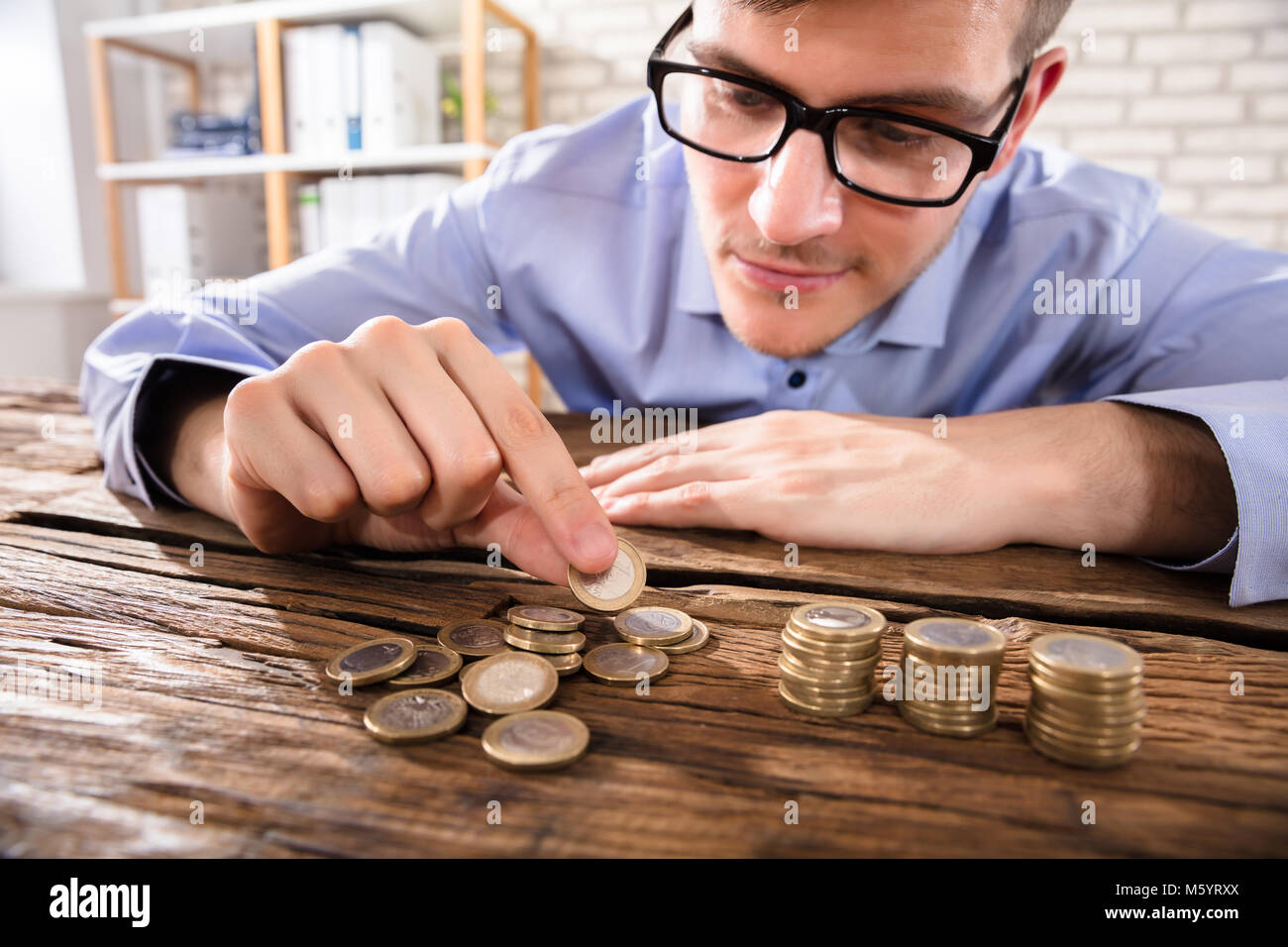 Counting coins hi-res stock photography and images - Alamy