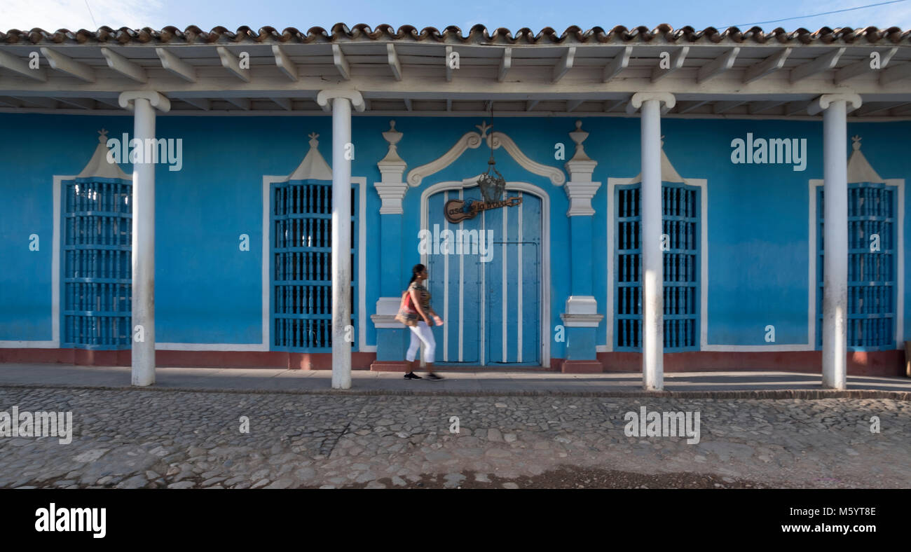 Residents in front of their typical Cuban house with wooden barred ...