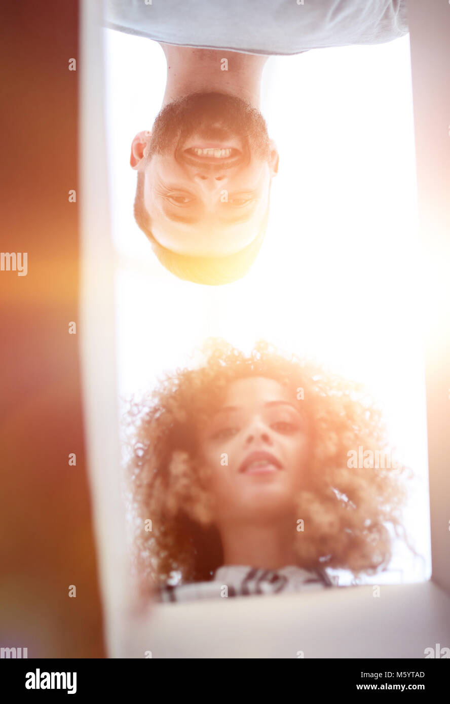 View from below a young couple looking inside the box Stock Photo - Alamy