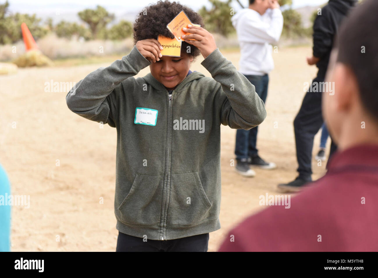 Student holds up card that reads overpopulation Stock Photo - Alamy