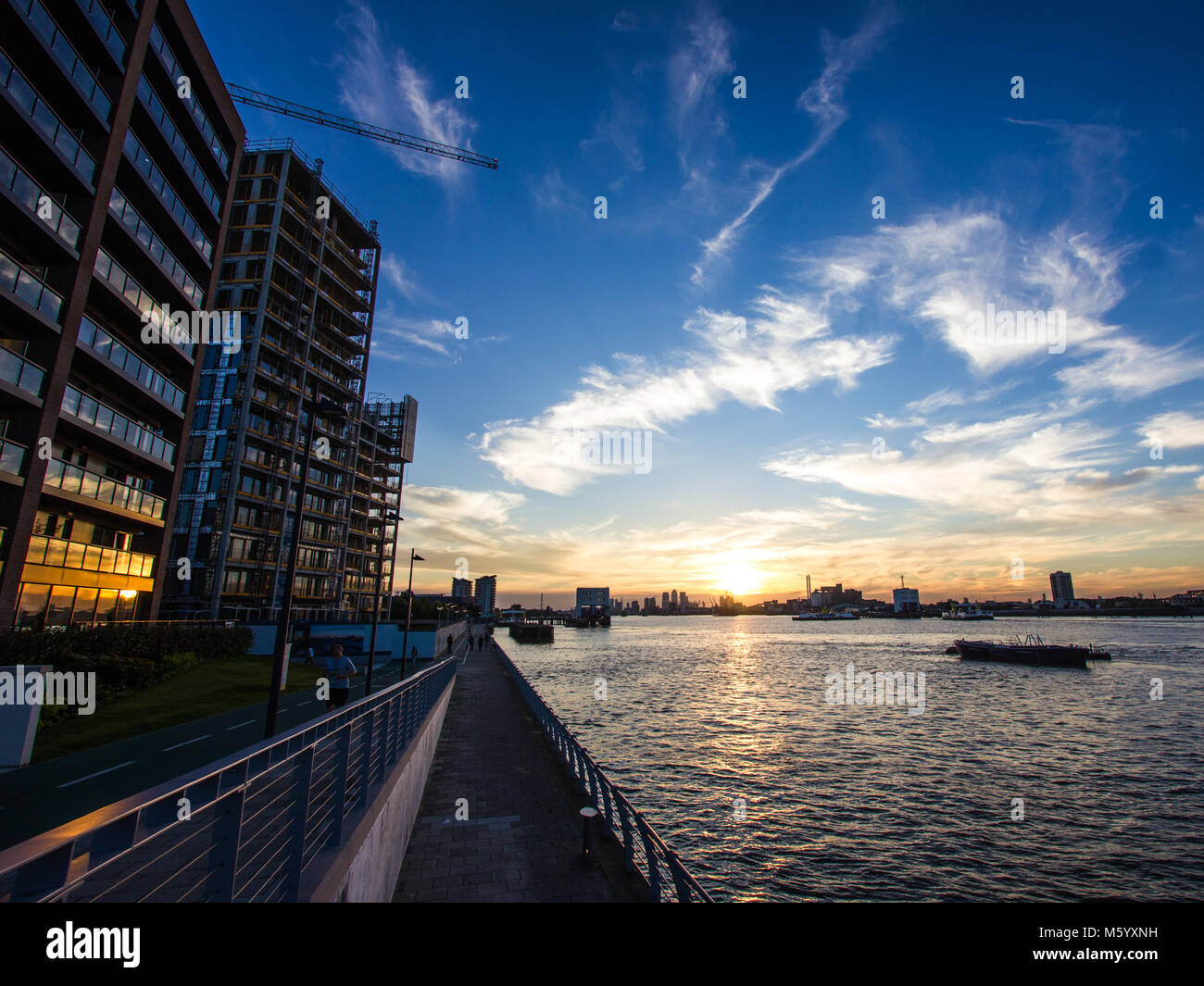 Sunset at Woolwich pier looking towards Canary Wharf Stock Photo - Alamy
