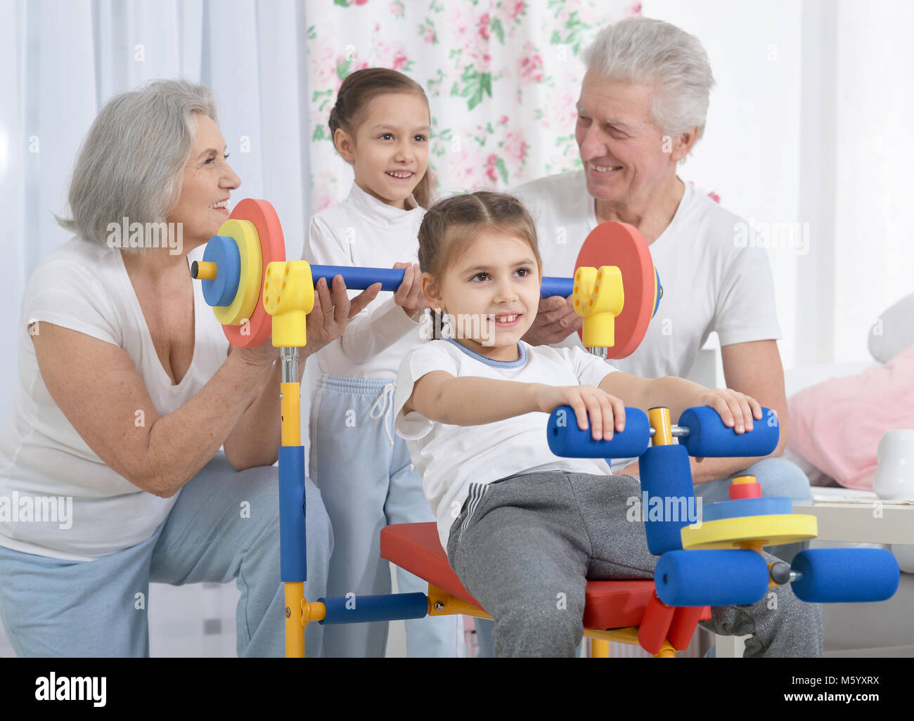 grandparents and little granddaughters doing exercises Stock Photo - Alamy