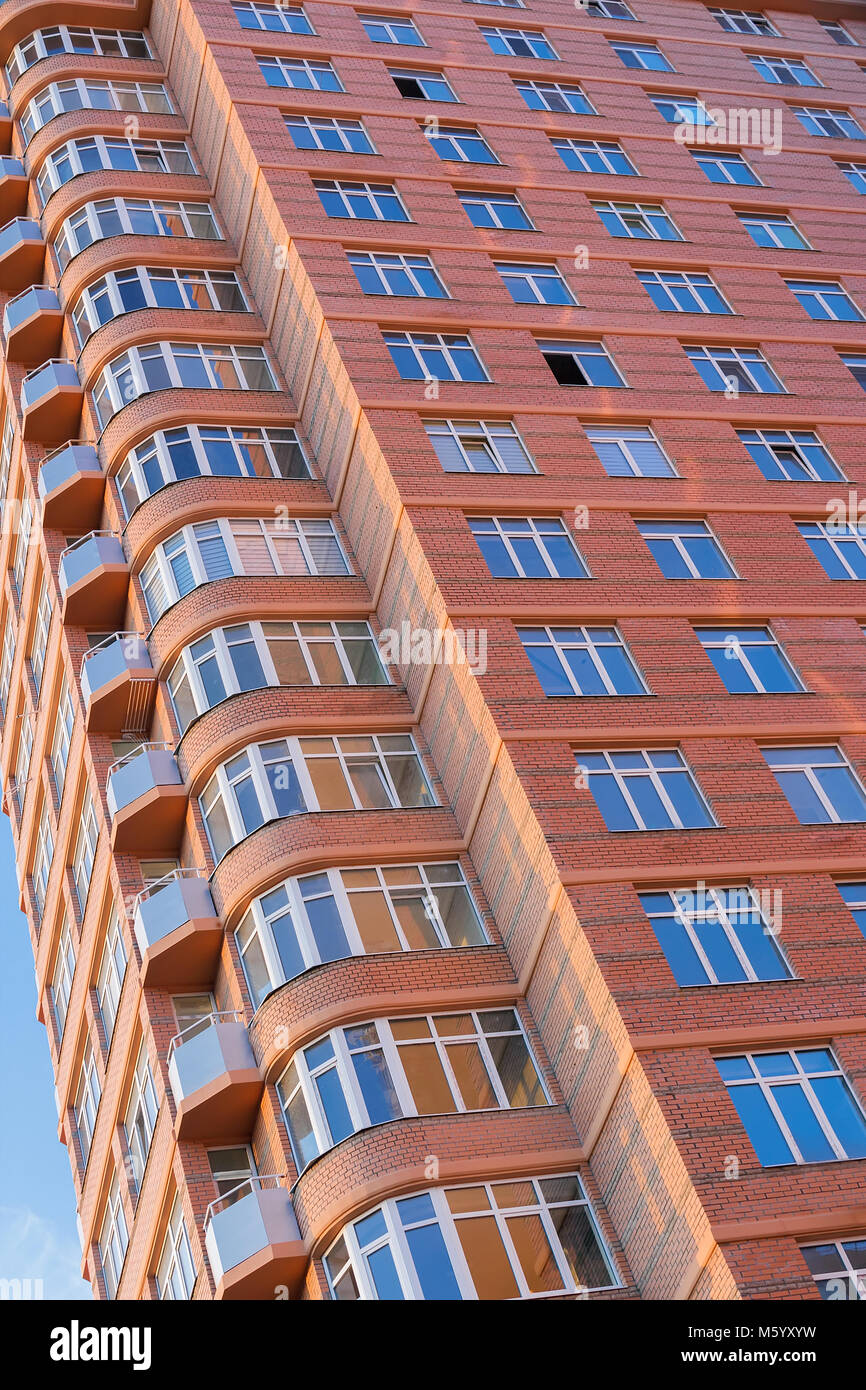 Beautiful facade of a new multi-storey residential building made of red ...