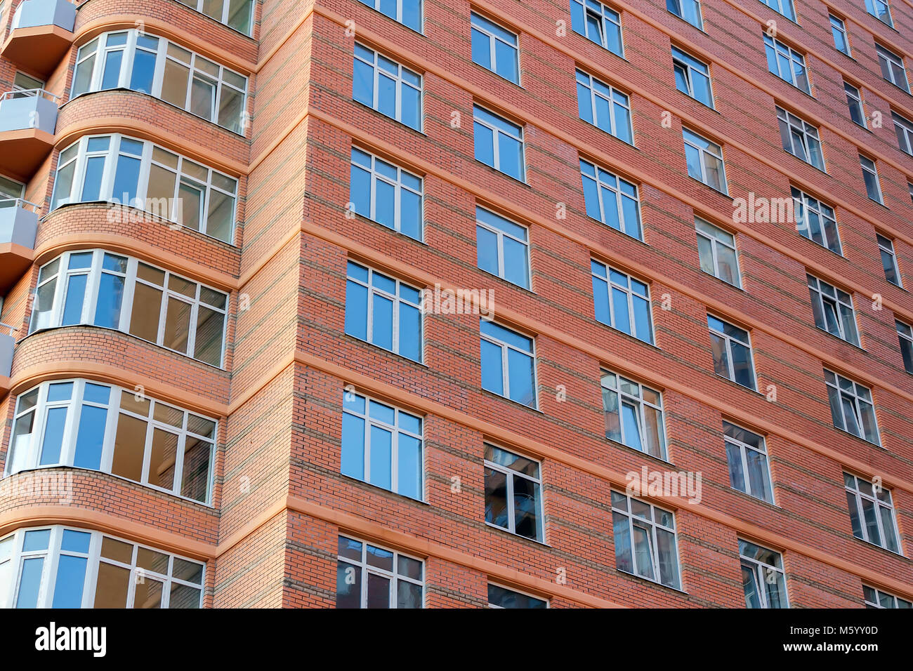 Beautiful facade of a new multi-storey residential building made of red ...