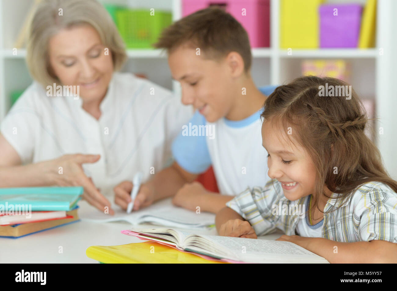 granny with grandchildren doing homework Stock Photo - Alamy