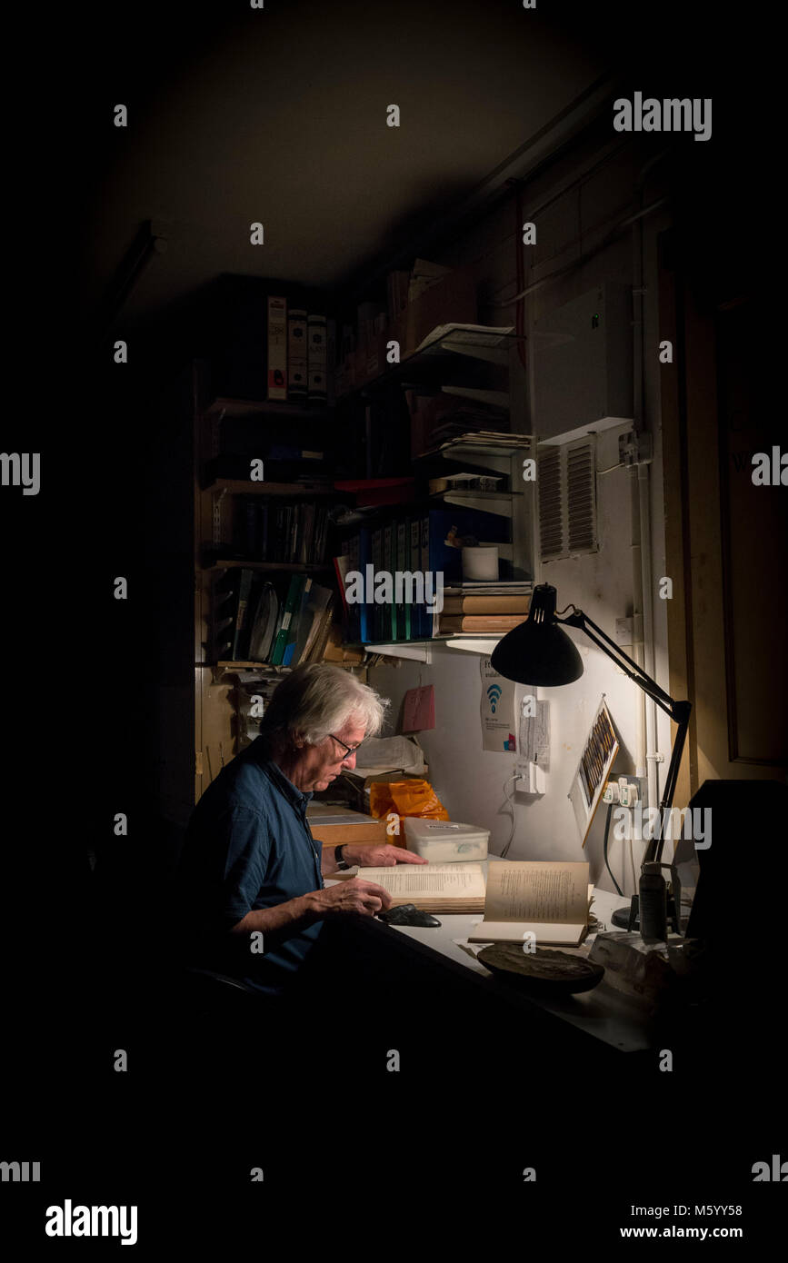 a museum worker poses amongst the collection and archive of the booth ...