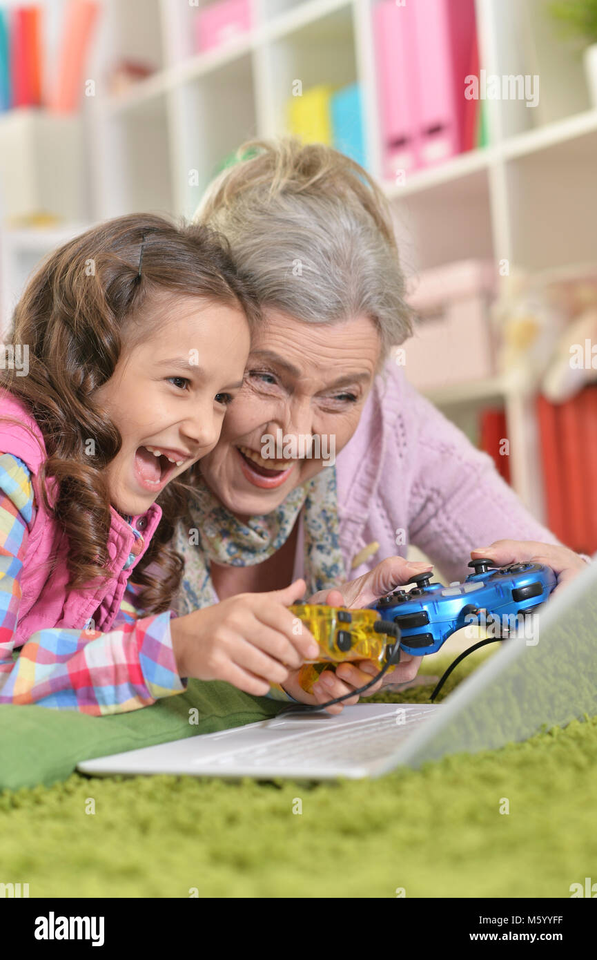granny with her granddaughter playing computer gam Stock Photo - Alamy