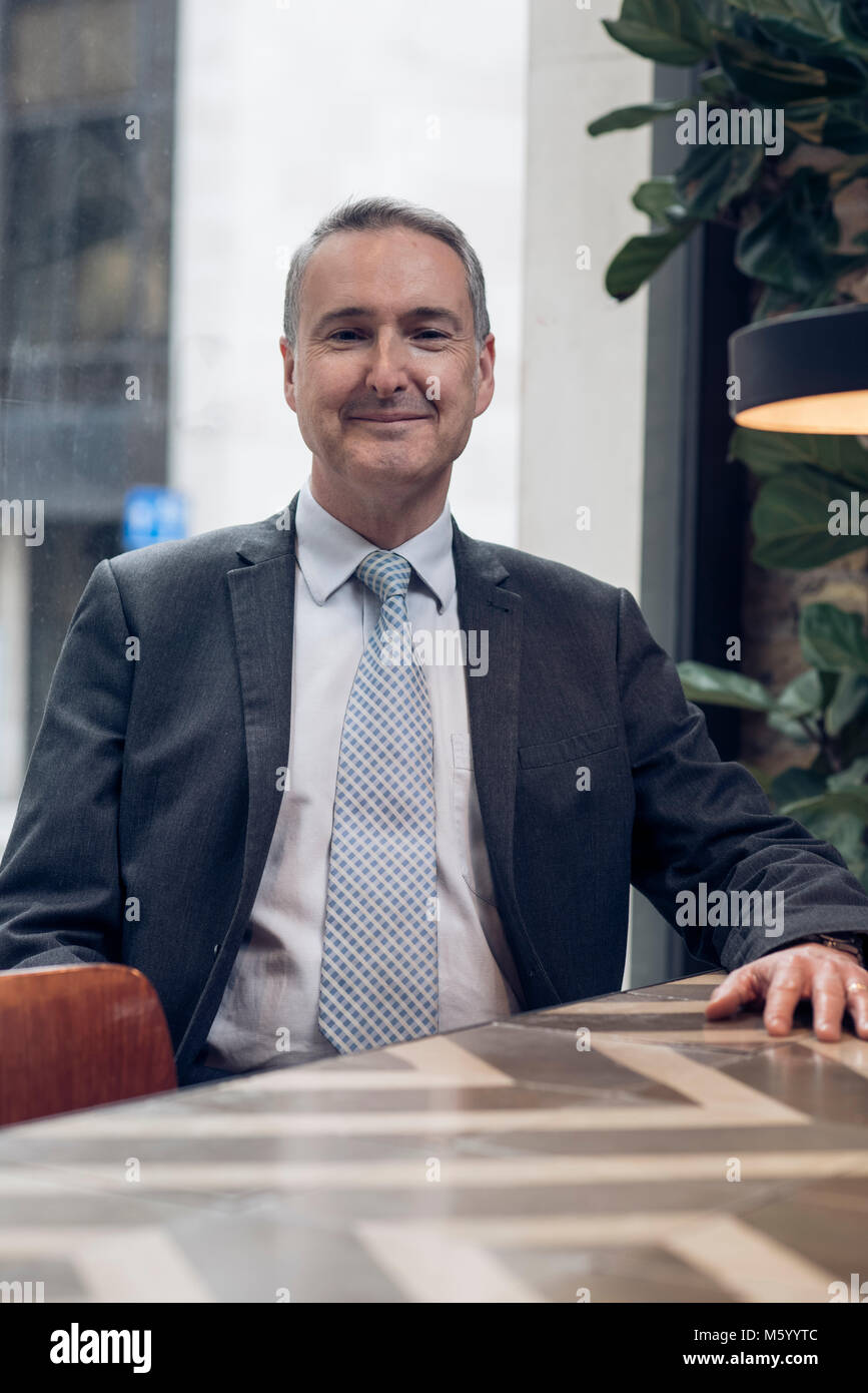 real management team profile photo taken in a designed relaxed cafe ...