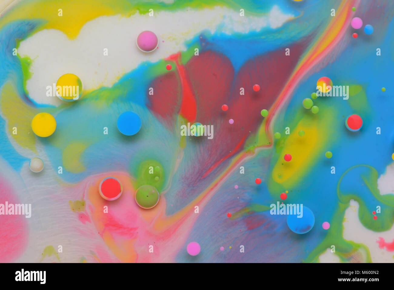 Oil, milk and water over colors Stock Photo - Alamy