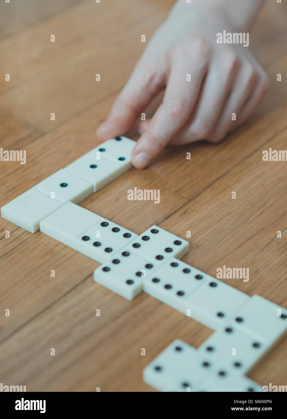 Child playing dominoes on the floor. Close-up view Stock Photo - Alamy