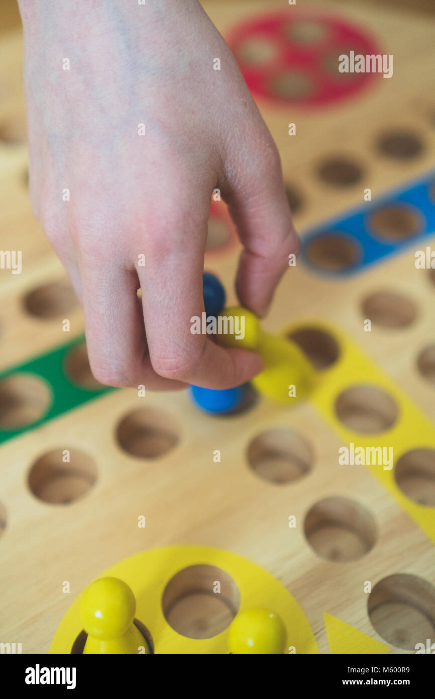 Child playing Ludo board game. Close-up view Stock Photo - Alamy