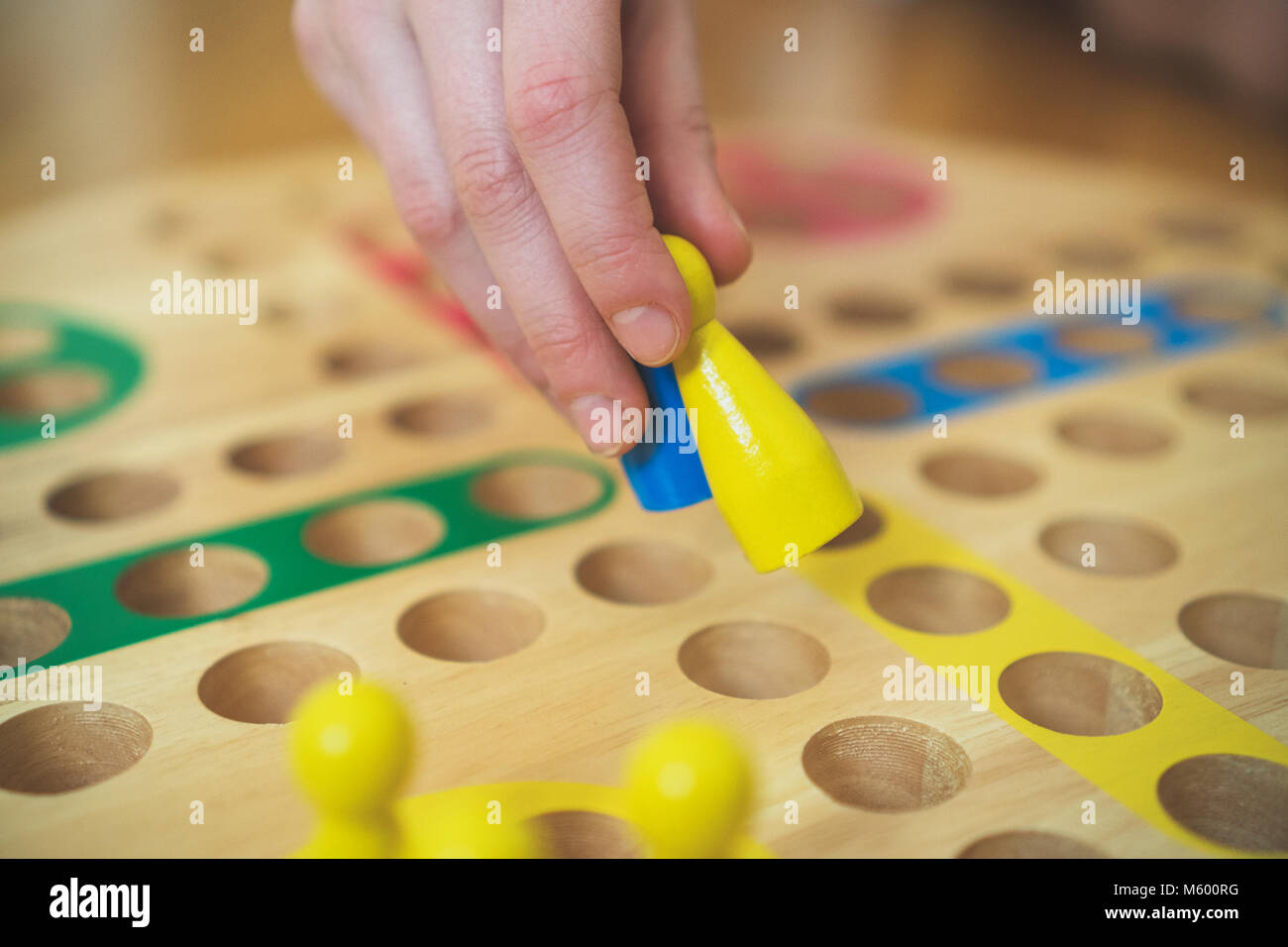 Child playing Ludo board game. Close-up view Stock Photo - Alamy