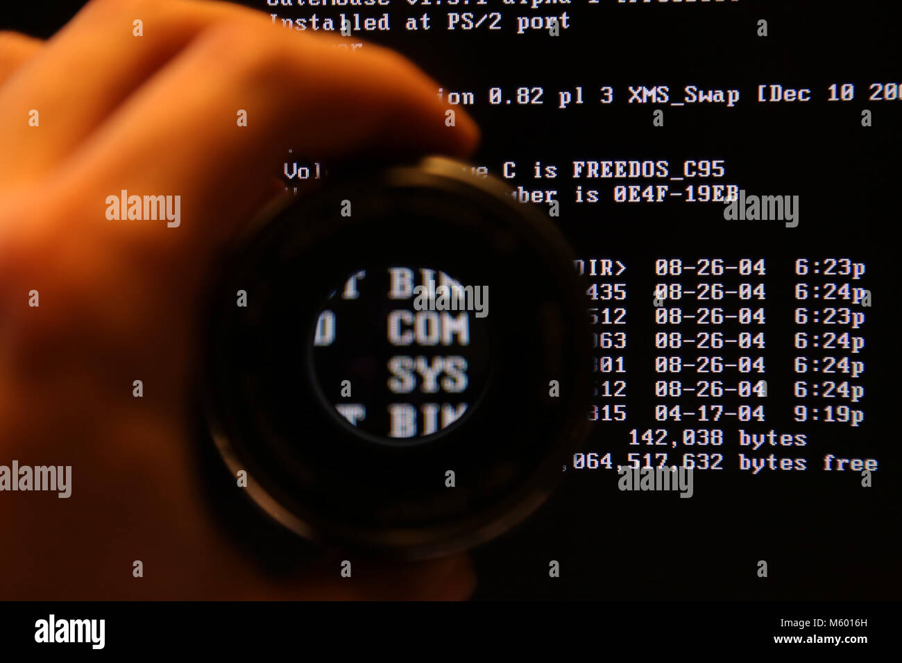 Dos on screen through magnify glass Stock Photo - Alamy