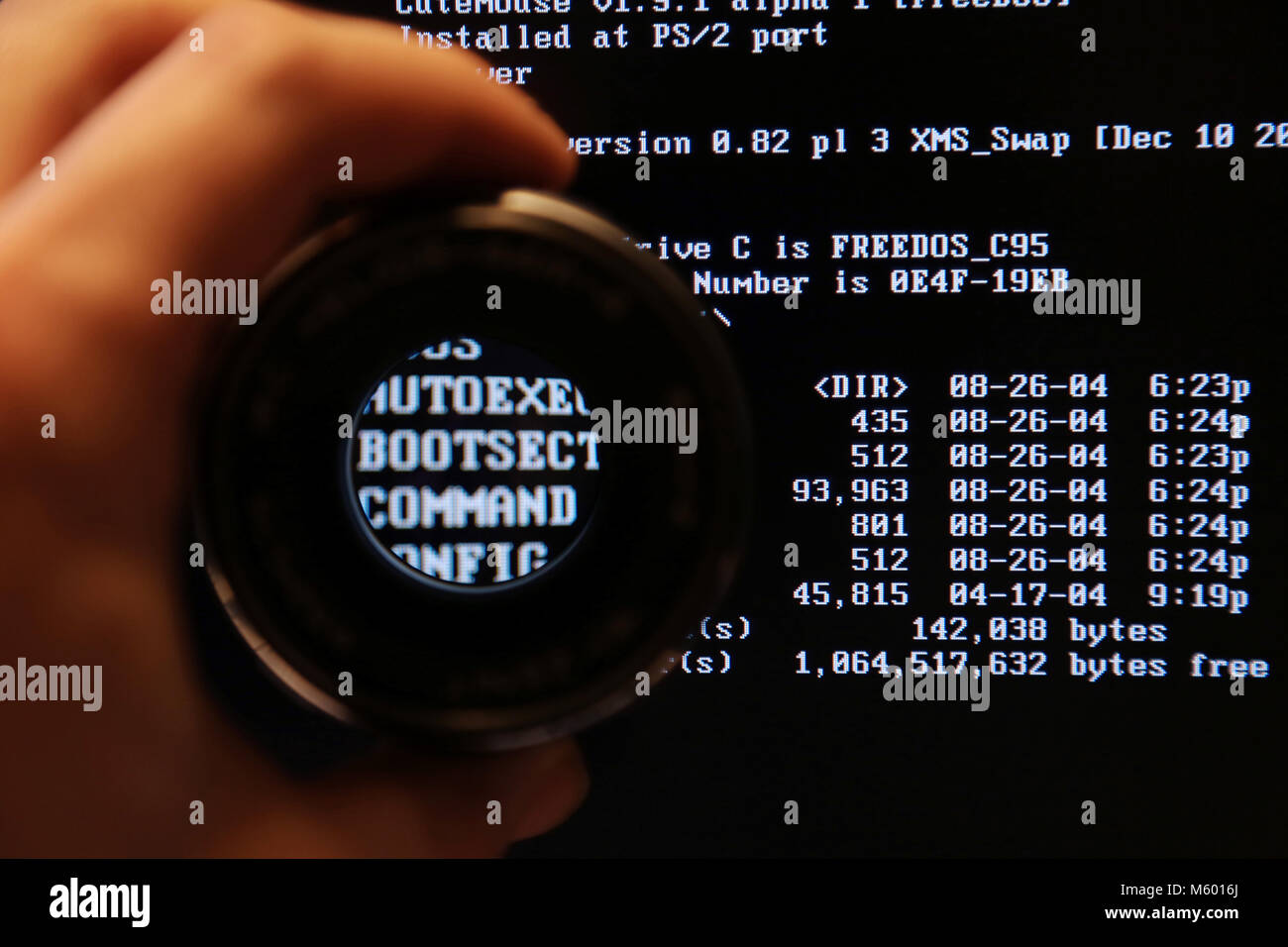 Dos on screen through magnify glass Stock Photo - Alamy