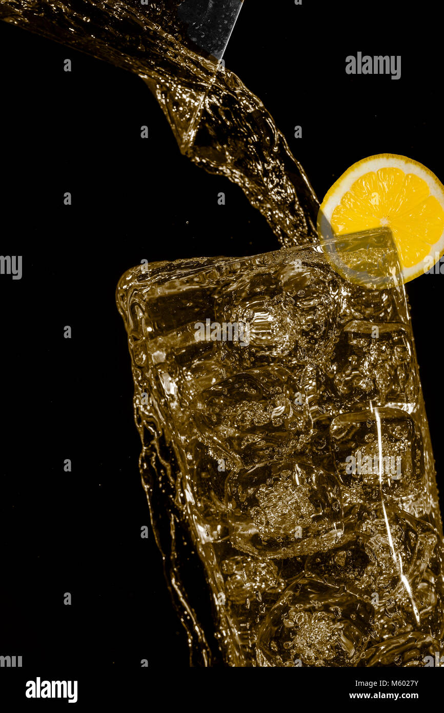 sparkling water overflow over ice cubes Stock Photo - Alamy