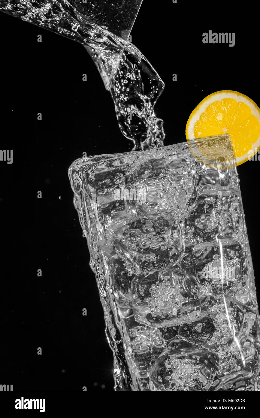 sparkling water overflow over ice cubes Stock Photo - Alamy