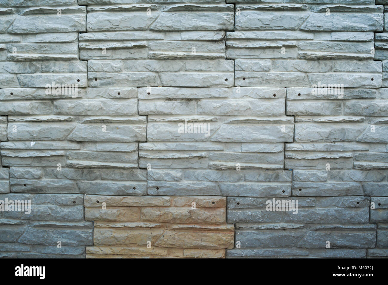 Gray concrete wall of large uneven square slabs that mimic natur Stock ...