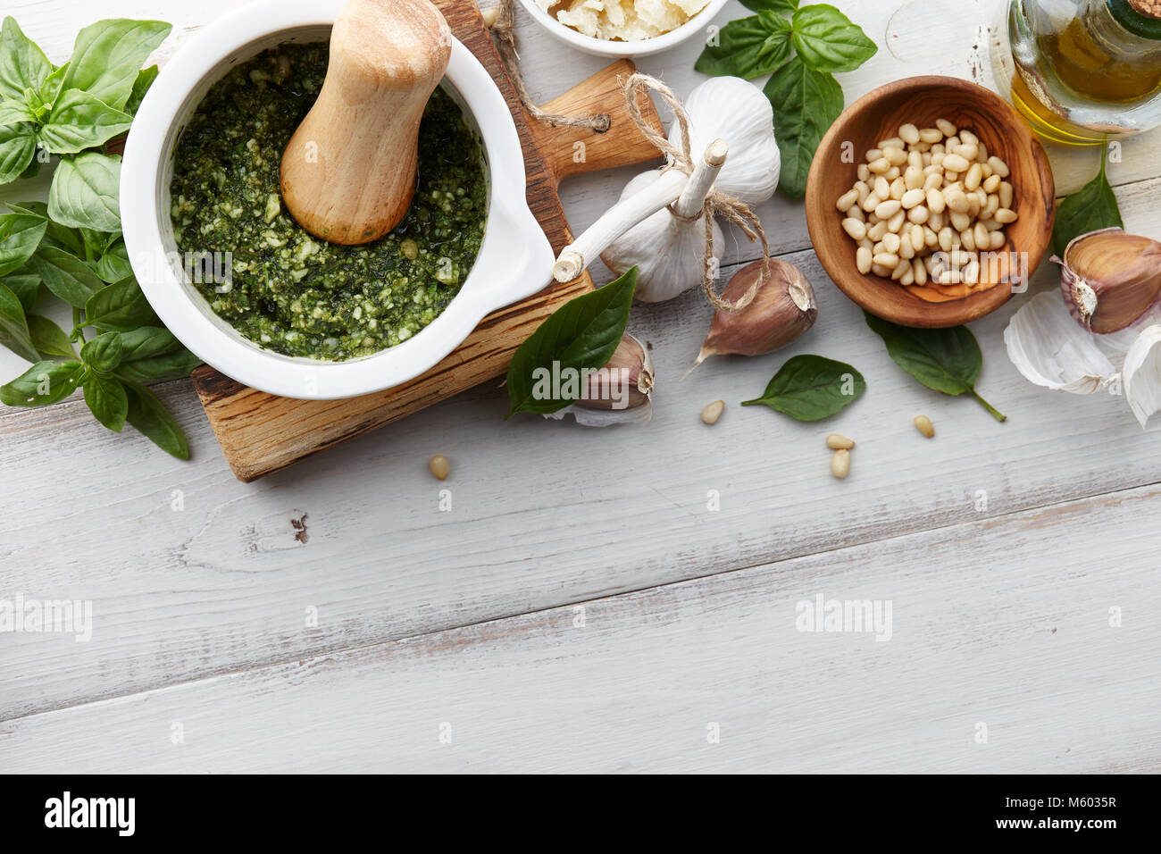Basil pesto sauce with main ingredients: fresh basil leaves, parmesan ...