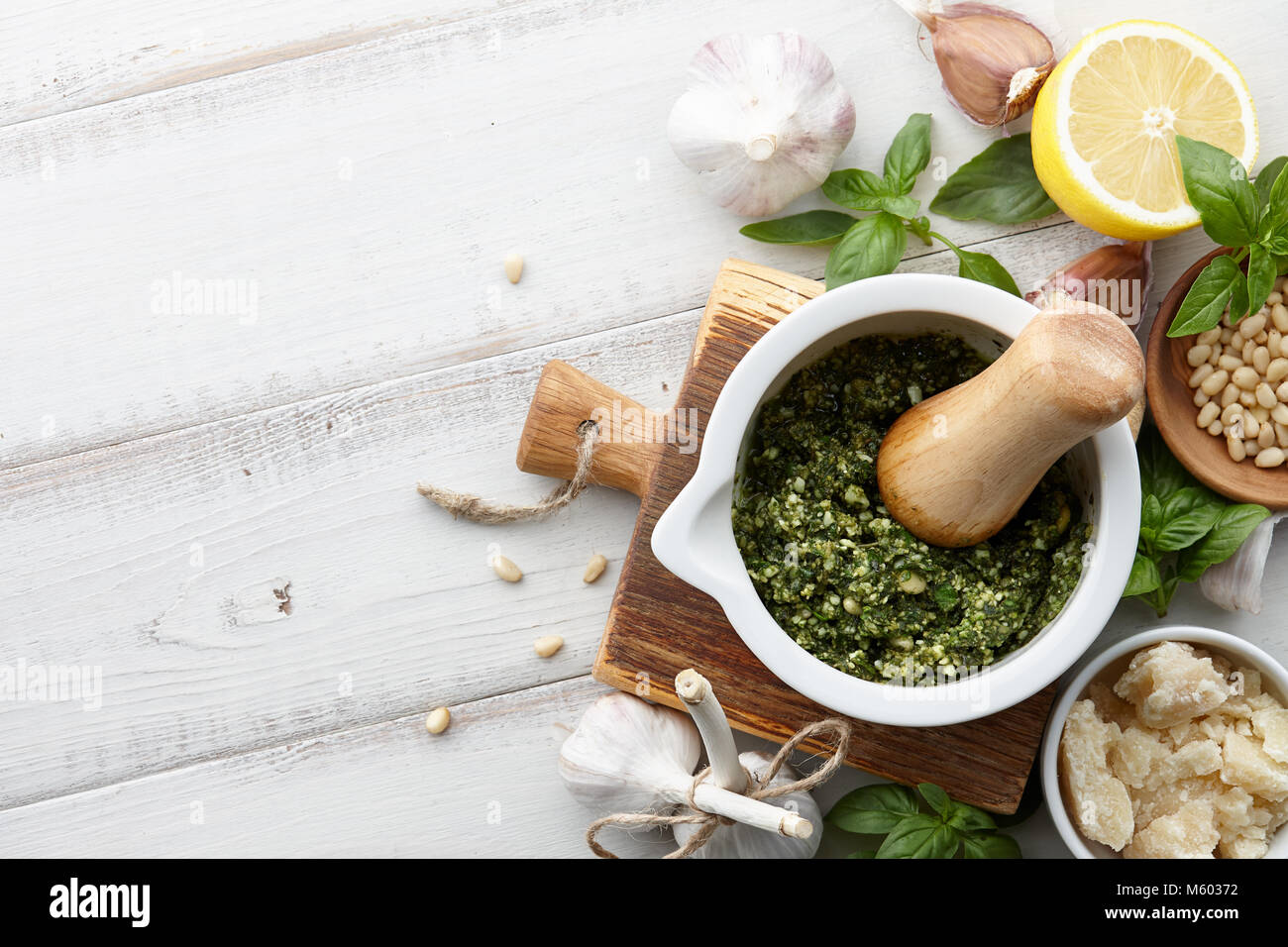 Basil pesto sauce with main ingredients: fresh basil leaves, parmesan ...