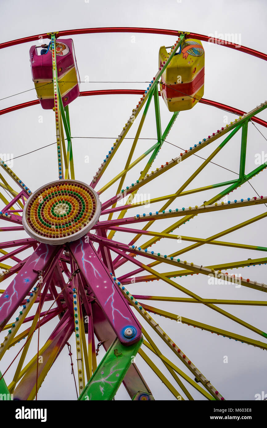 Ferris wheel with multicolored cabins in amusement park. Luna Park ...