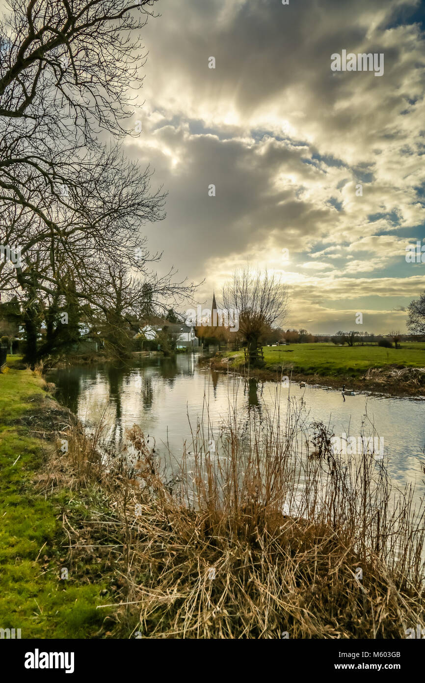The pretty riverside village of Denton with its church steeple in ...