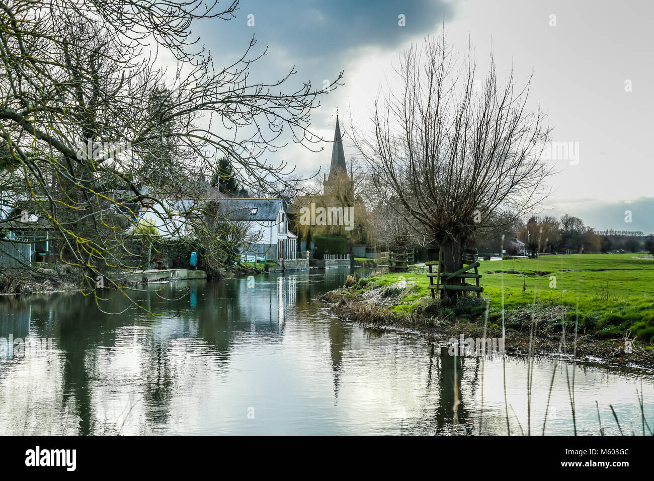 The pretty riverside village of Denton with its church steeple in ...