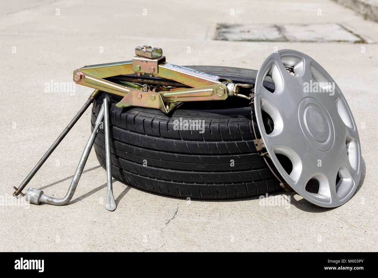 fixing car tire problem concept, car tire and jack Stock Photo - Alamy