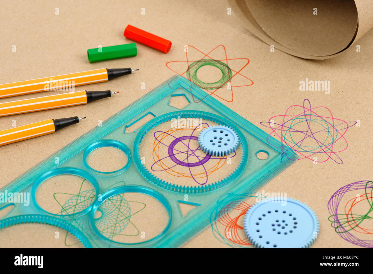 Drawing the spirograph pattern with spirograph kit Stock Photo - Alamy