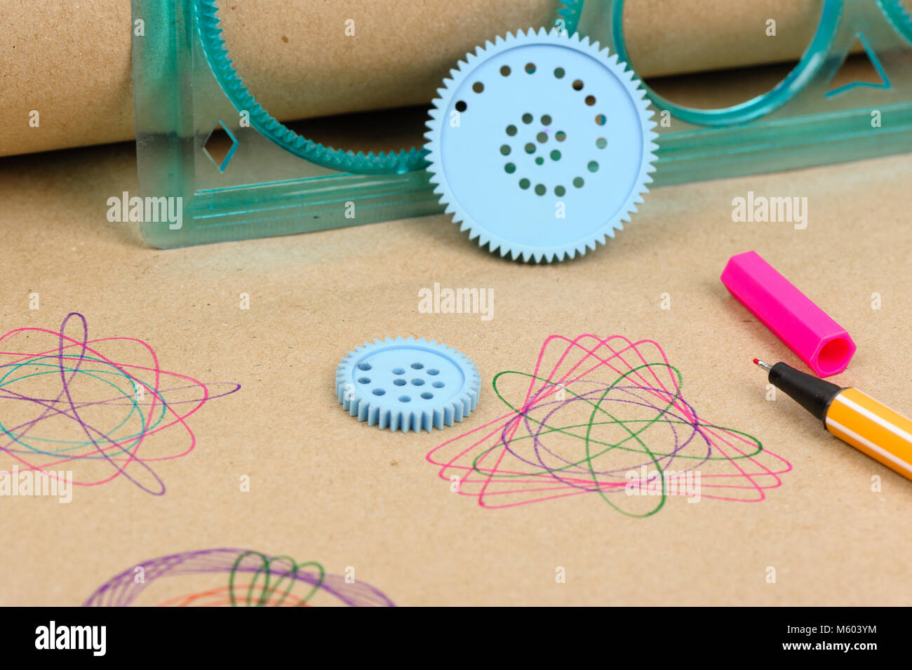 Drawing the spirograph pattern with spirograph kit Stock Photo - Alamy