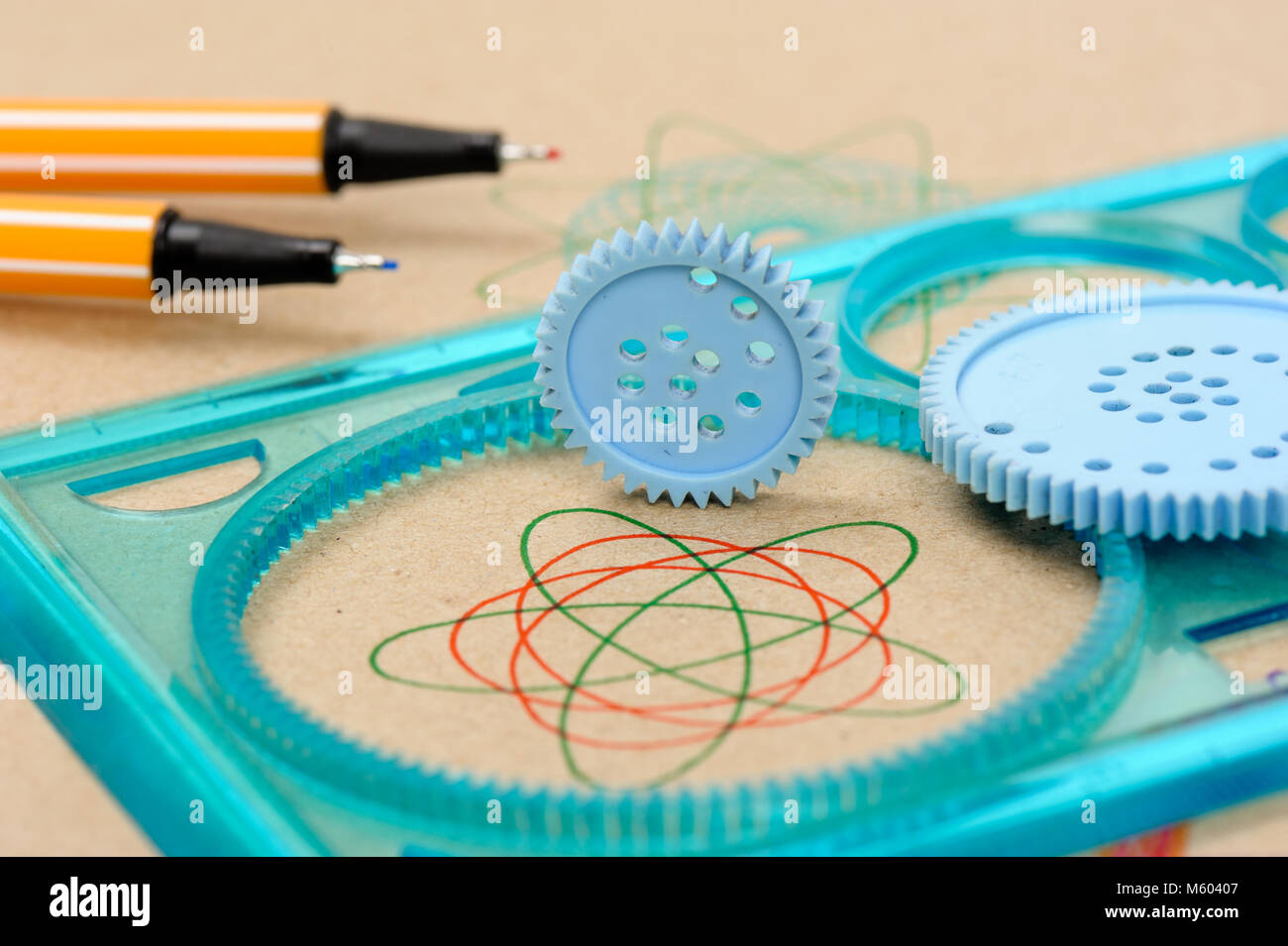 Drawing the spirograph pattern with spirograph kit Stock Photo - Alamy