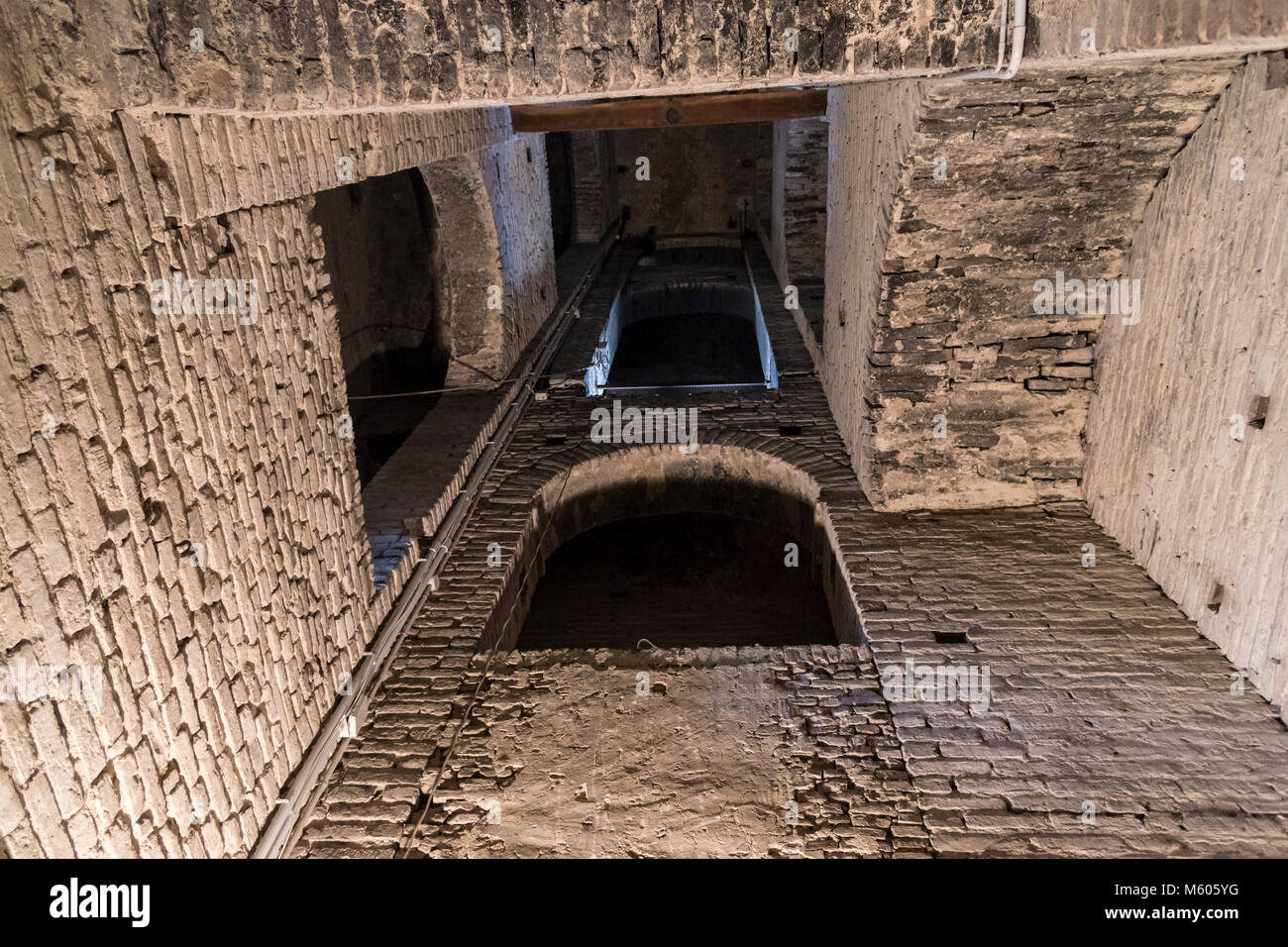 Stone interior with window of an old steeple crypt, located inside an ...
