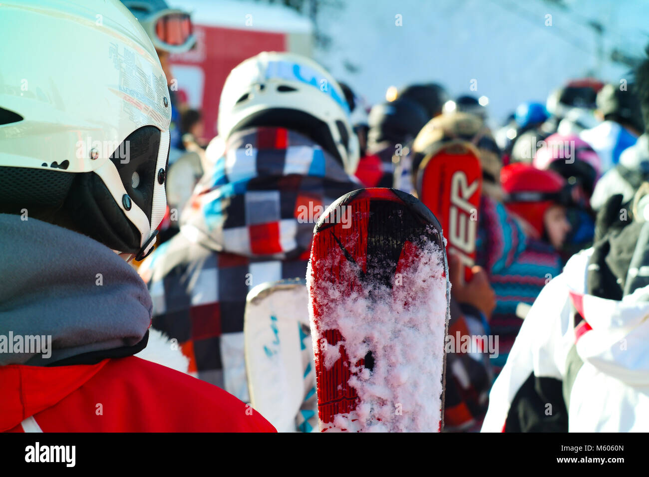 Winter sports: Group of people with skis and snowboards waiting in line ...