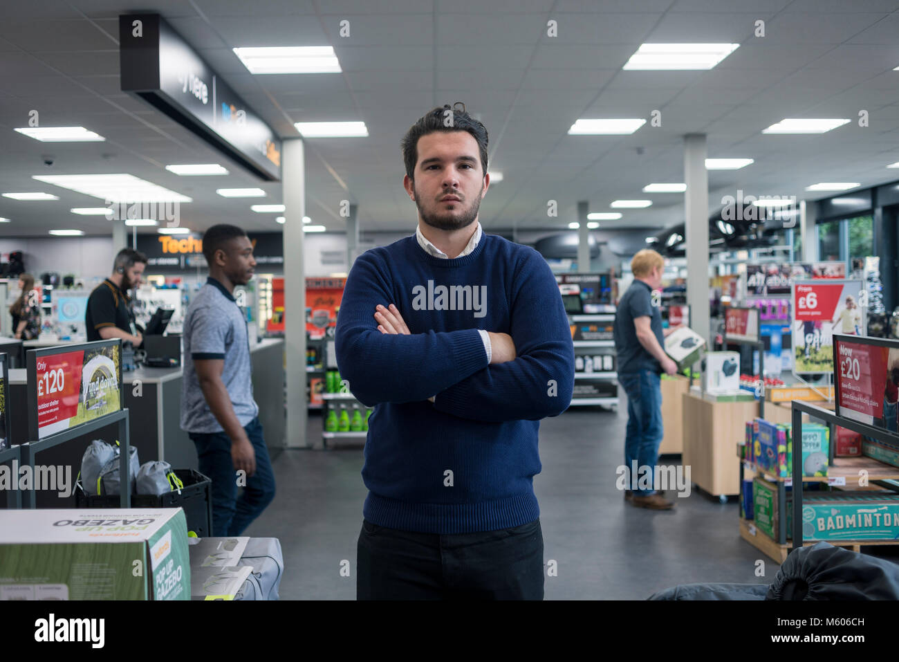 a real person / customer stands in a halfords autocentre with the sales ...