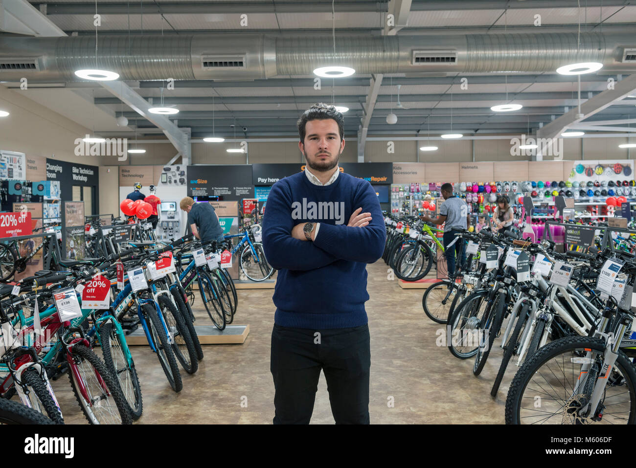 a real person stands in a halfords retail shop in a retail park in the ...