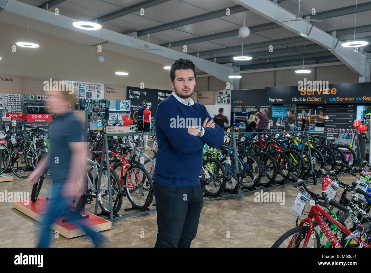 a real person stands in a halfords retail shop in a retail park in the ...