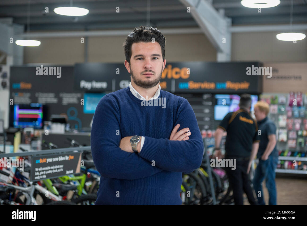a real person stands in a halfords retail shop in a retail park in the ...