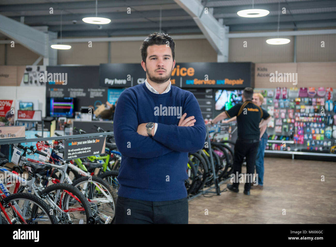 a real person stands in a halfords retail shop in a retail park in the ...