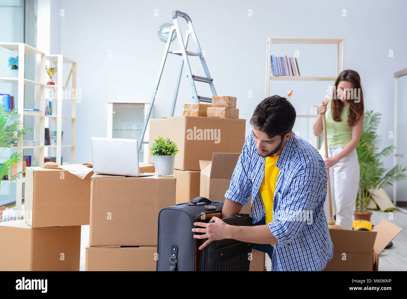 Young family unpacking at new house with boxes Stock Photo - Alamy
