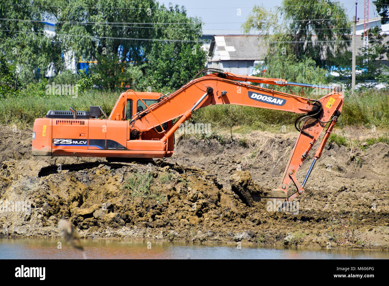 Excavator digs clay in the Quarry with clay. Extraction of clay Stock ...