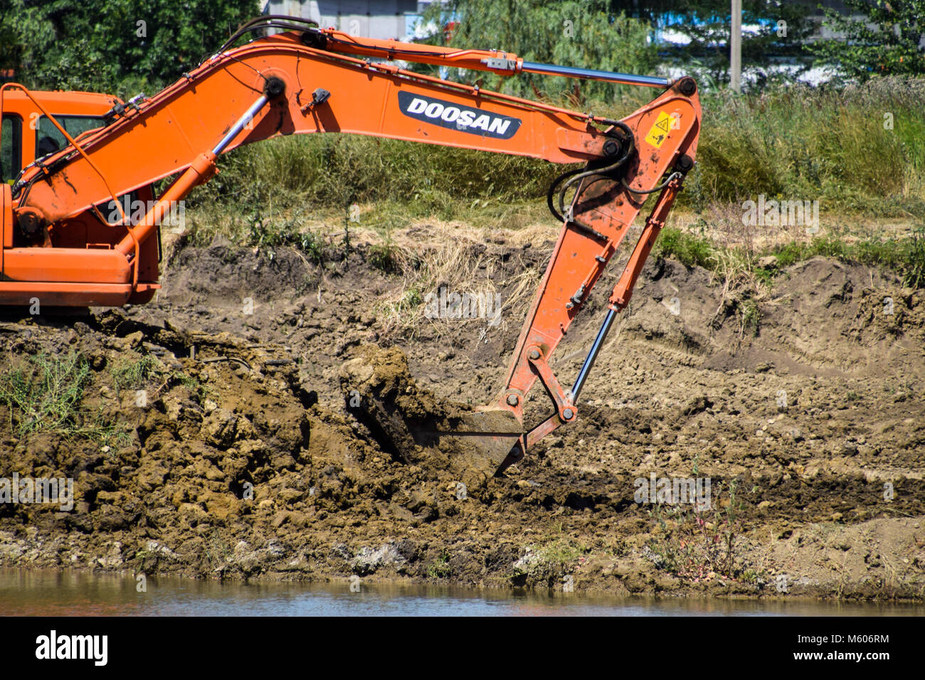 Excavator digs clay in the Quarry with clay. Extraction of clay Stock ...