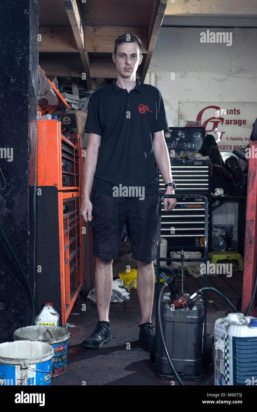 local small business owners mechanics pose for a portrait on the garage ...