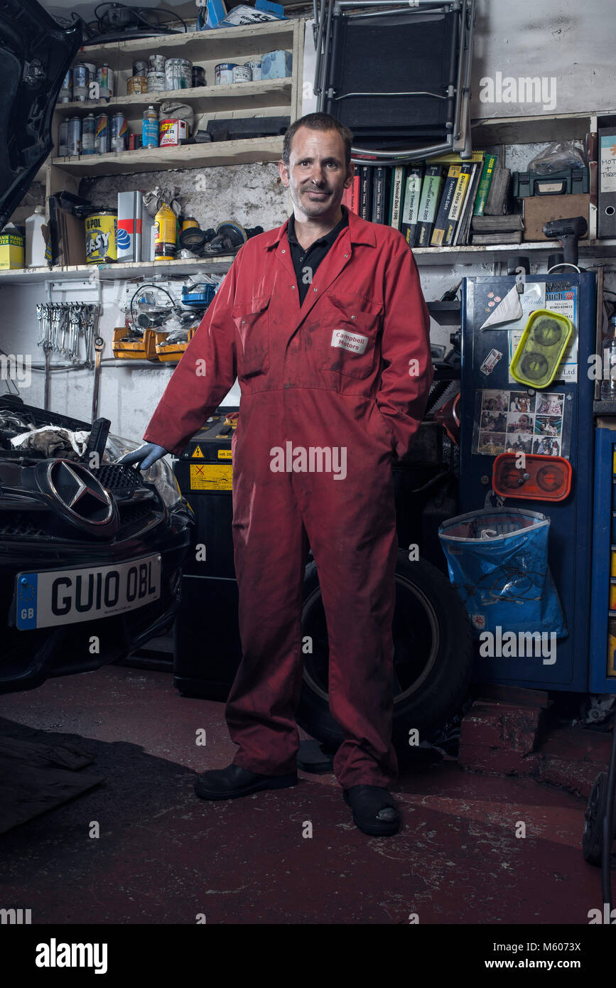 local small business owners mechanics pose for a portrait on the garage ...