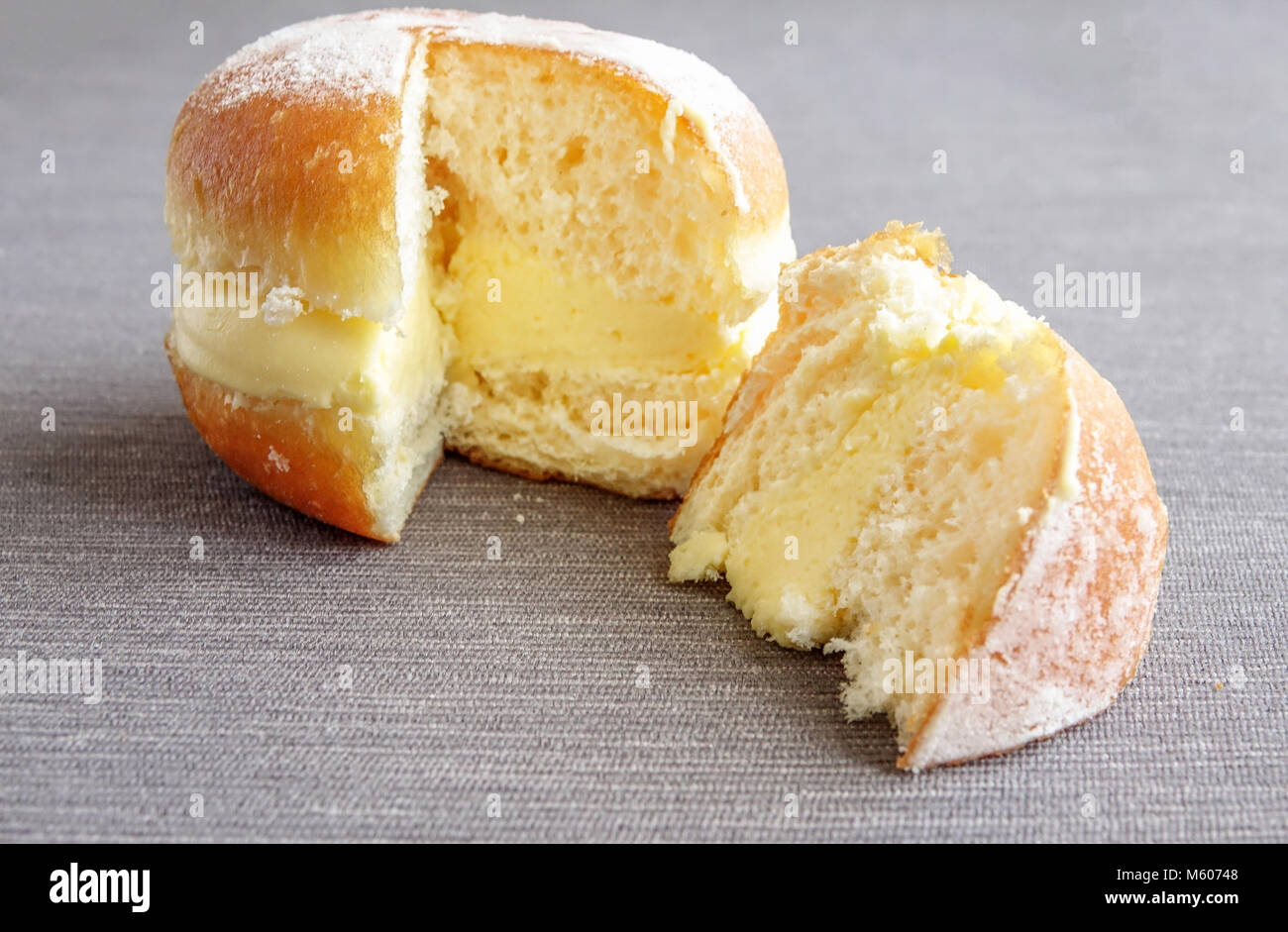 A cut open custard cream doughnut Stock Photo - Alamy