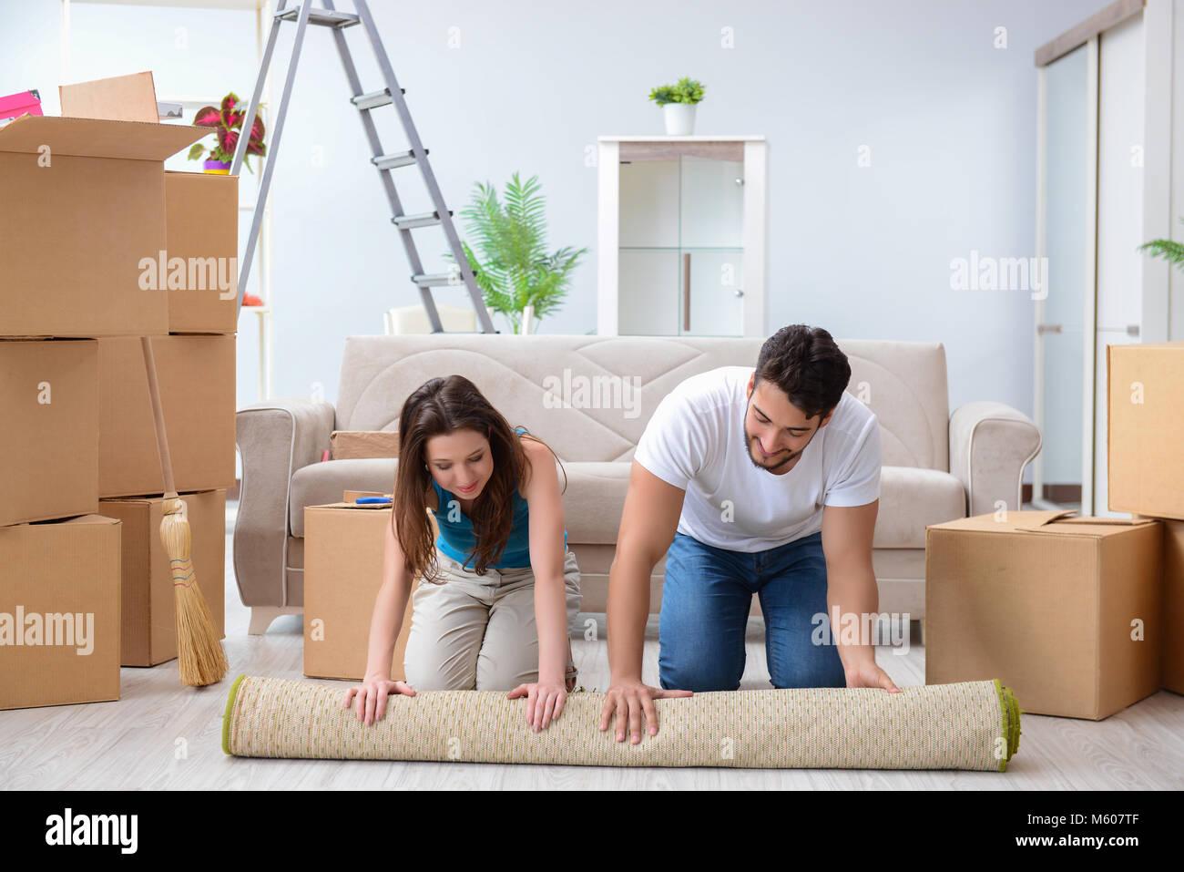 Young family unpacking at new house with boxes Stock Photo - Alamy