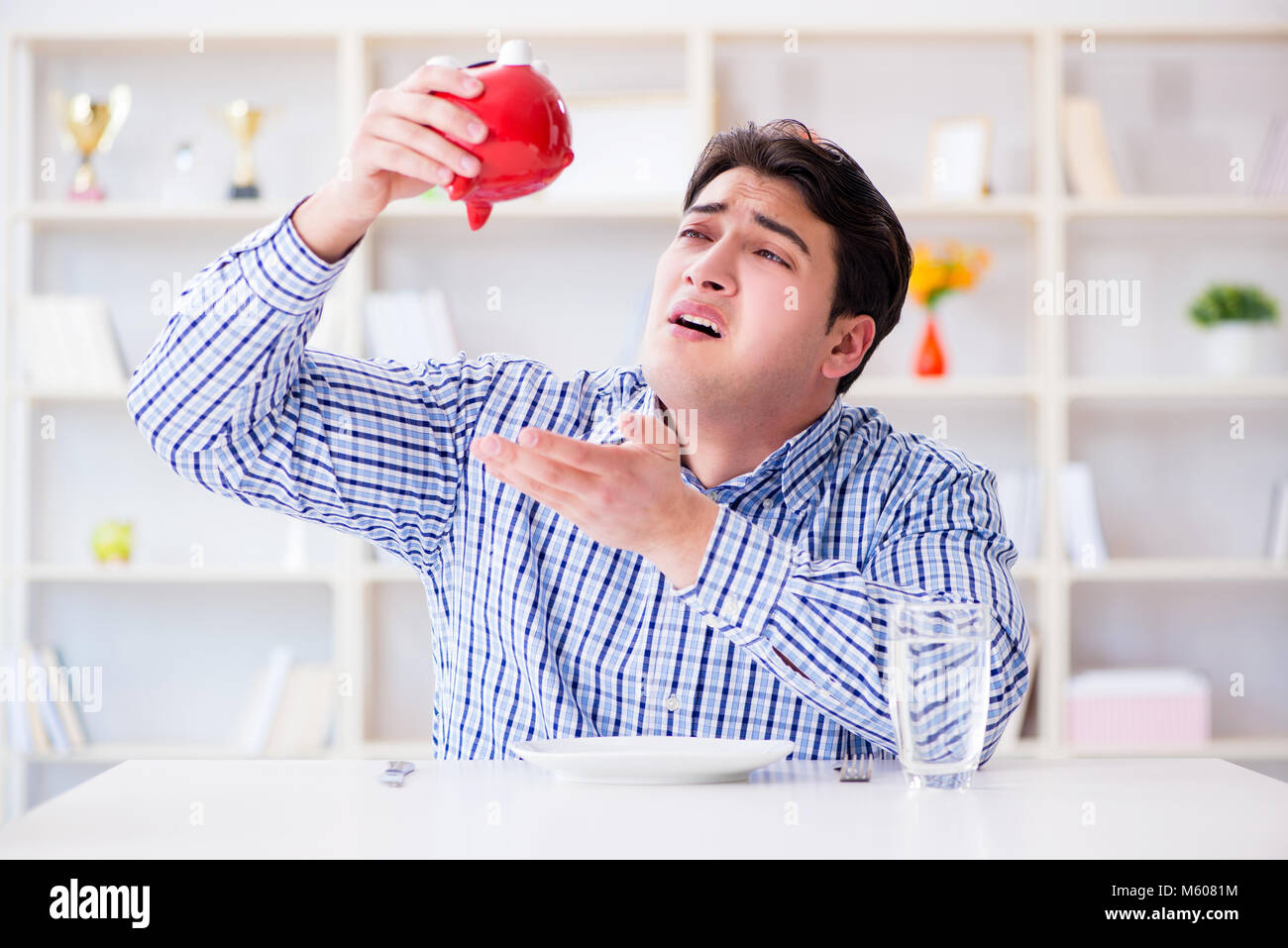 Man running out of money in restaurant and using savings from piggy ...