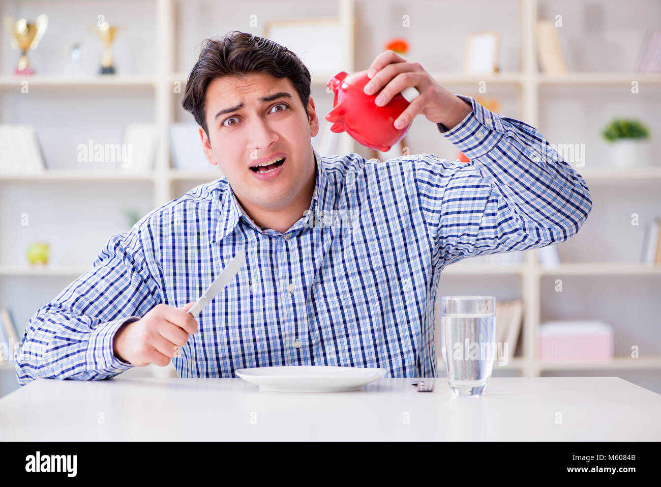 Man running out of money in restaurant and using savings from piggy ...