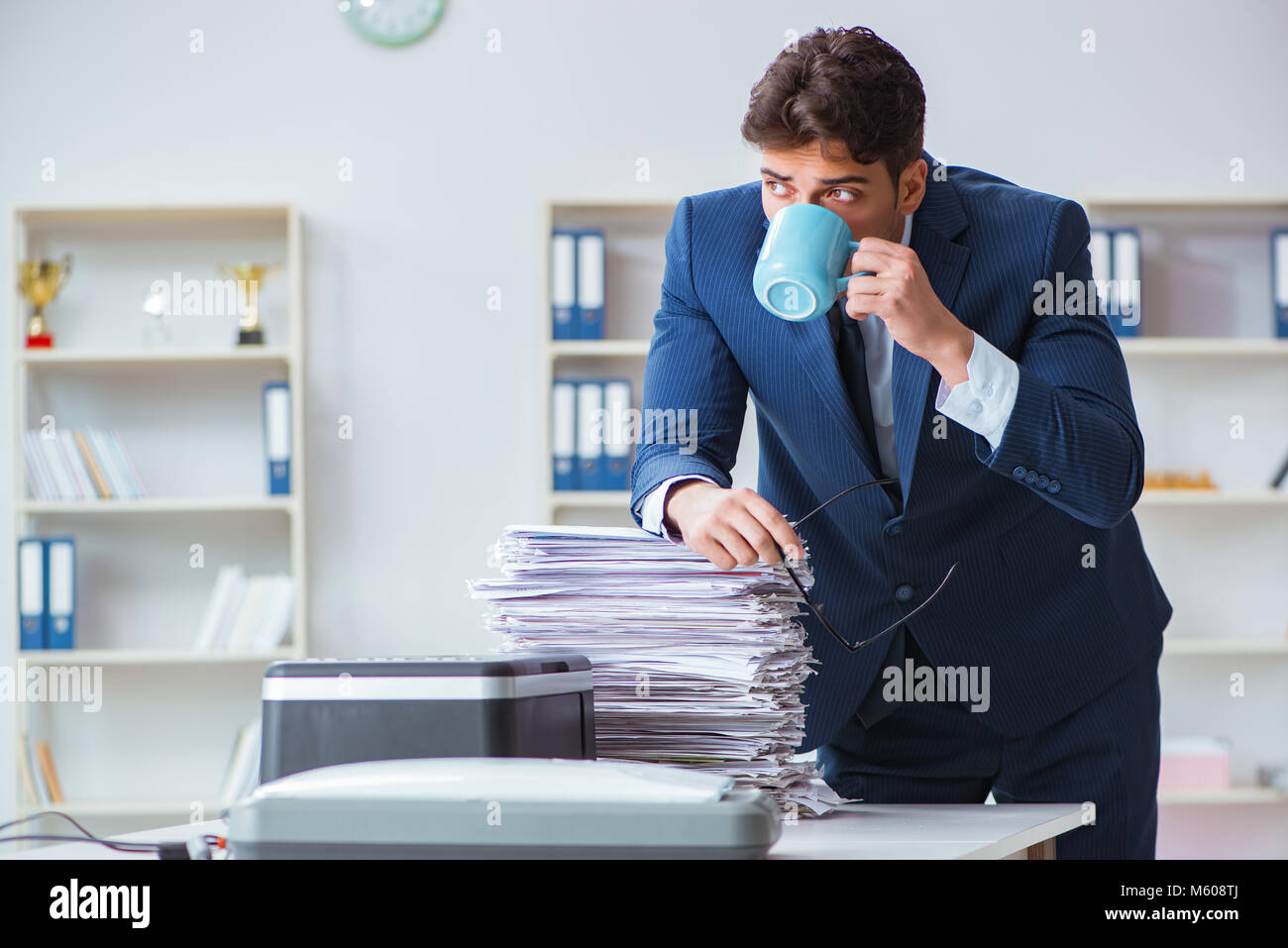 Businessman making copies in copying machine Stock Photo - Alamy