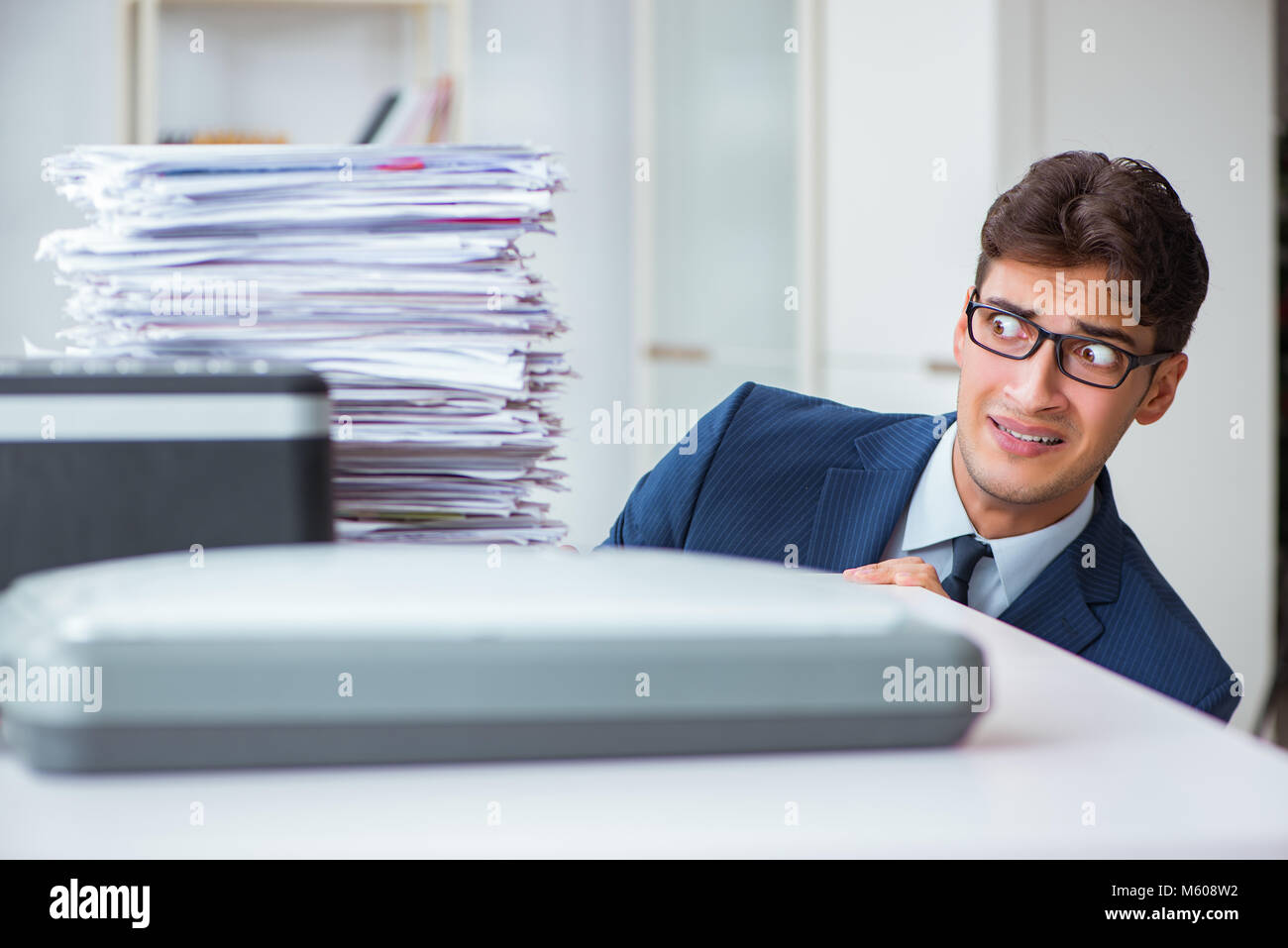 Businessman making copies in copying machine Stock Photo - Alamy