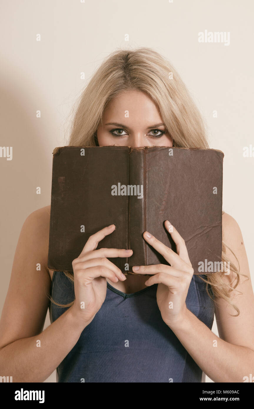Hands hiding open book hi-res stock photography and images - Alamy