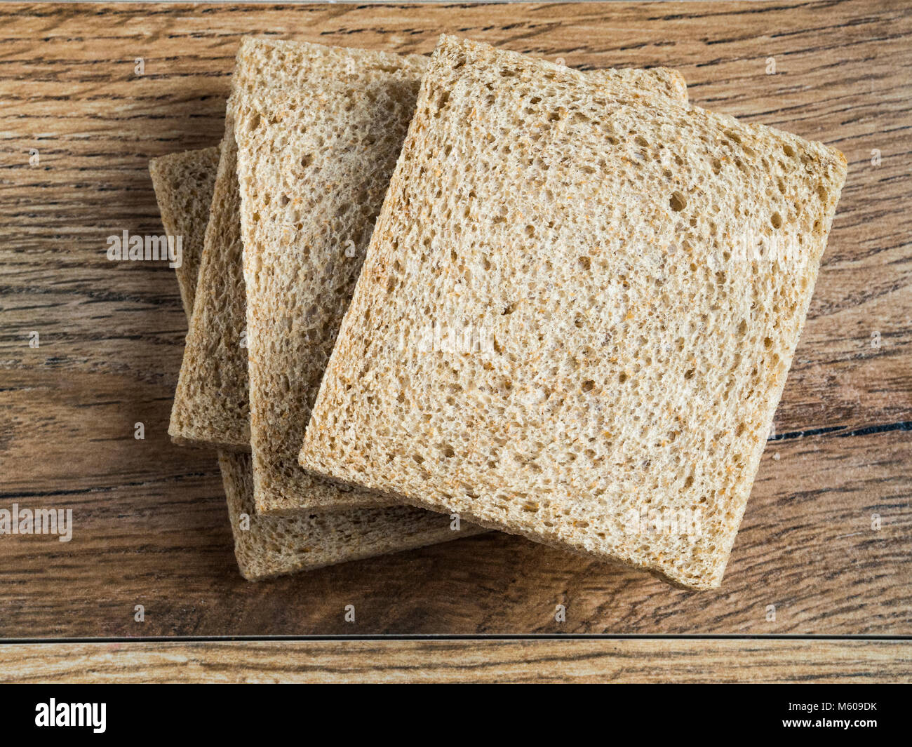 Wholemeal bread without crust on wood background Stock Photo - Alamy